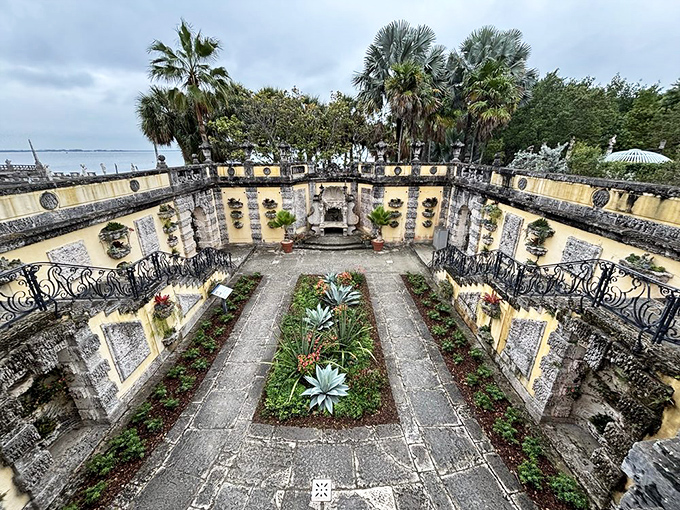 This sunken garden courtyard feels like a secret room without a ceiling, where plants and stone create an outdoor sanctuary.