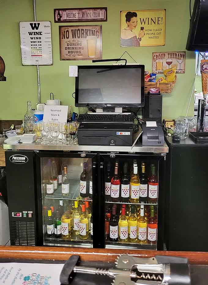 Behind the bar, bottles wait patiently while witty signs remind us that wine makes everything better, especially working hours.
