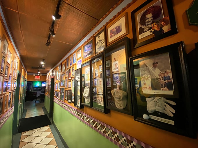 Sports memorabilia and framed photos line the hallway, telling stories of community connections and the restaurant's place in local history.