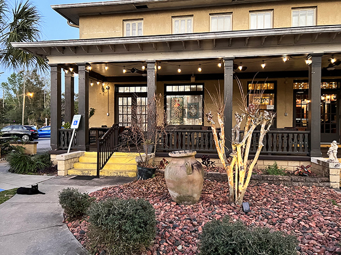 Evening brings a special ambiance to this wraparound porch where rocking chairs sometimes move on their own. String lights create a festive atmosphere for both living and spectral guests.