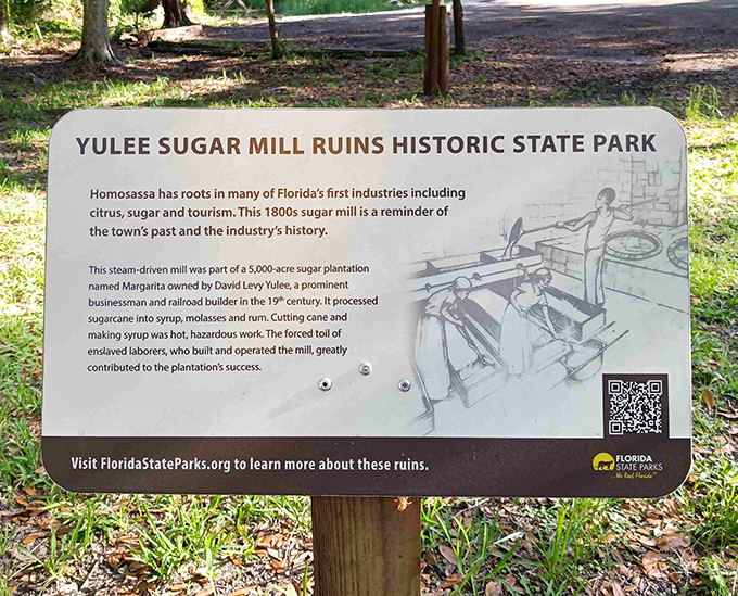 This informative sign doesn't sugarcoat history, acknowledging the forced labor that powered this once-profitable industrial operation.