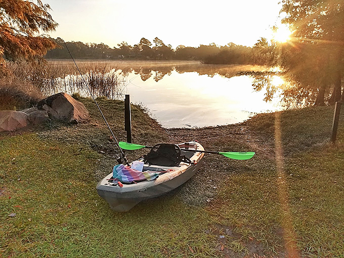 Dawn breaks over Secret Lake as a kayak waits patiently for its human to begin another day of aquatic exploration.