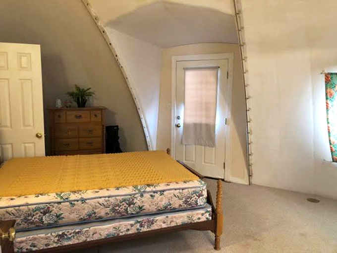 Another bedroom showcases how dome architecture creates uniquely cozy spaces, with curved walls that feel protective rather than confining or claustrophobic.