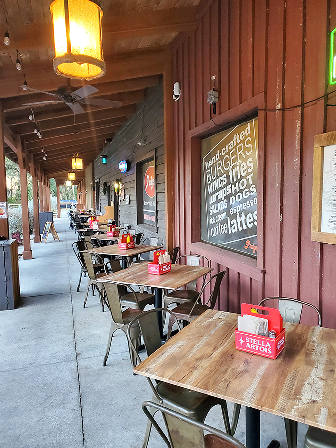 The covered patio offers al fresco dining with a side of people-watching &ndash; wooden tables waiting for the next round of food adventurers.