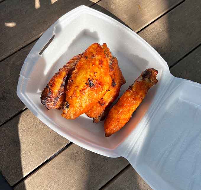 These wings look like they've been kissed by fire and blessed by flavor gods, arriving at your table ready to disappear in record time.