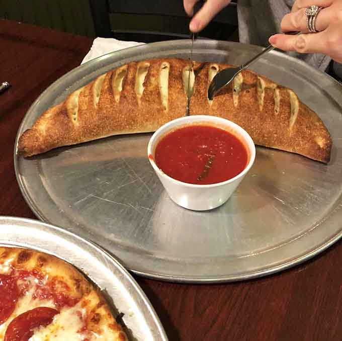 Calzones here are basically pizza folded in on itself, creating a portable pocket of cheesy, meaty perfection.