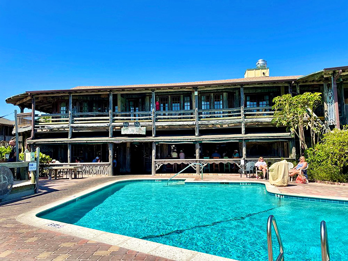 The resort pool offers a refreshing blue oasis framed by weathered wood balconies &ndash; Old Florida luxury without a hint of pretension.