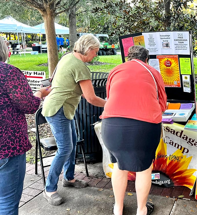 Information booths offer curious visitors a chance to learn about upcoming tours and readings, the camp's sunflower logo shining bright against educational materials.