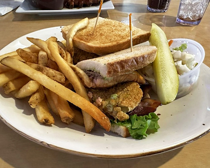 This sandwich doesn't just satisfy hunger – it conquers it, with layers of flavor stacked between toast and those hand-cut fries stealing the show.