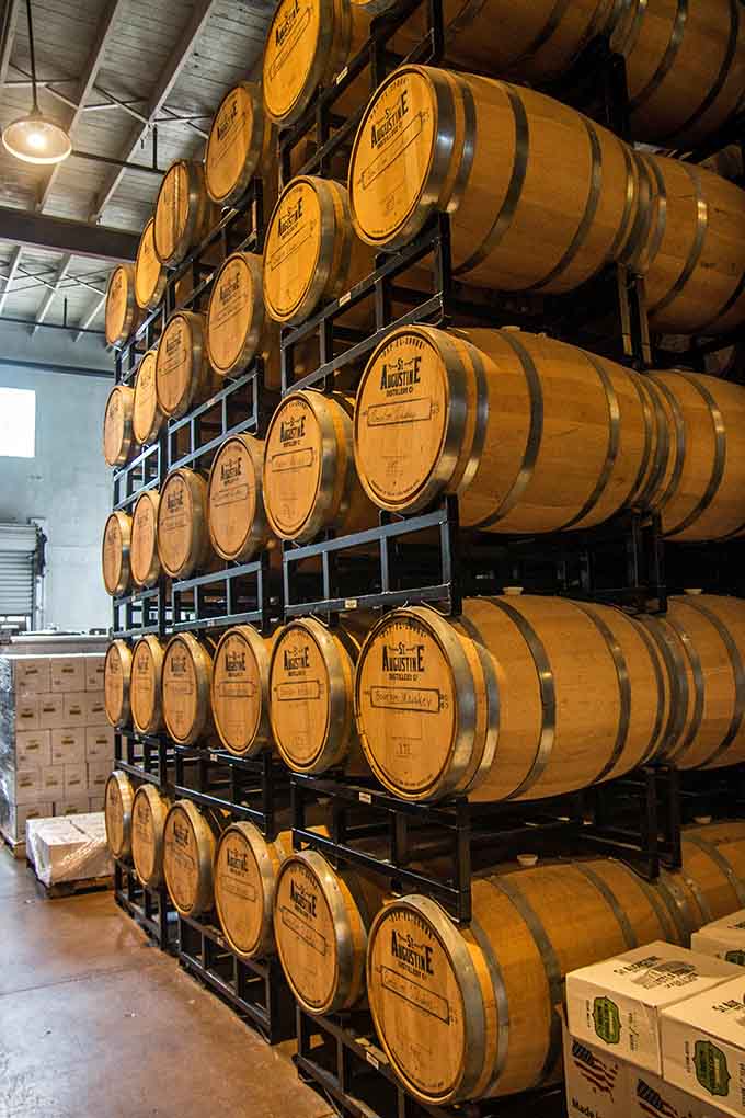 Rows of oak barrels stacked high hold tomorrow's wines, aging patiently like they've got all the time in the world.
