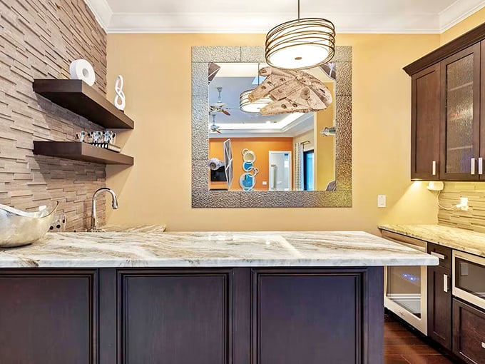 Even the secondary kitchen shines with personality &ndash; textured stone walls and modern lighting proving no detail was too small for consideration.