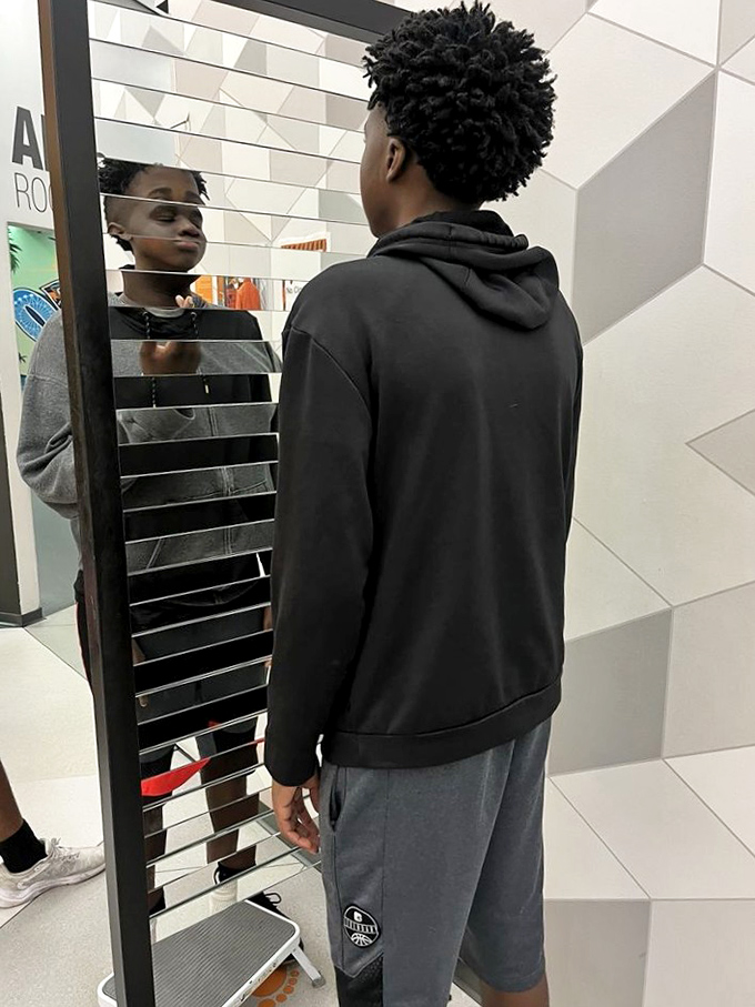 This segmented mirror transforms reflections into a surreal, fragmented version of reality that challenges visual perception.