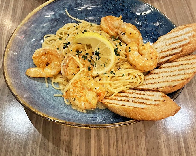 Plump shrimp and al dente pasta share the spotlight with grilled bread that's ready for its sauce-sopping destiny.