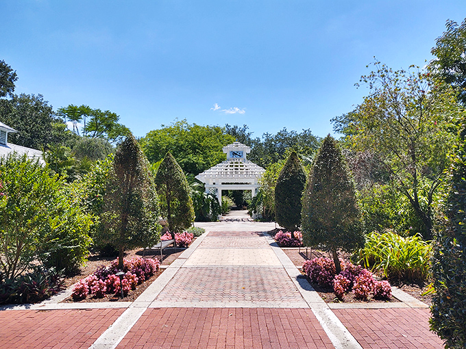 The garden pavilion creates a perfect frame for the path beyond, like a doorway to another, more perfect world.