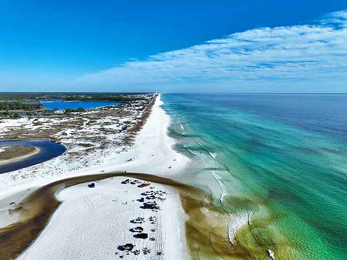 From above, the true magic reveals itself &ndash; a perfect ribbon of white sand separating emerald Gulf waters from coastal dune lakes.