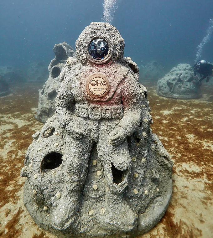 This atmospheric diving suit sculpture pays homage to underwater explorers while creating a playground for actual ocean dwellers.