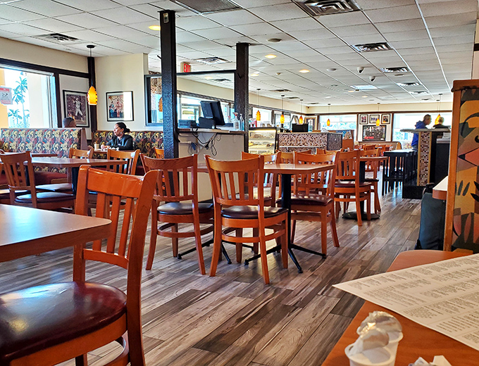 The dining area hums with the symphony of clinking silverware and coffee cup refills. These wooden chairs have supported generations of satisfied diners.