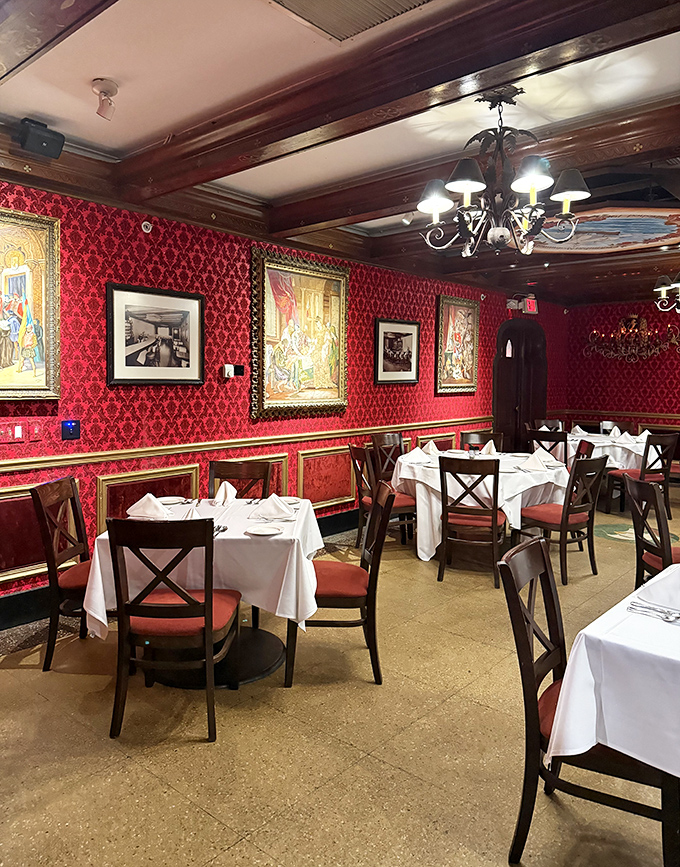 Rich red damask walls and white tablecloths create a dining room that feels both regal and welcoming&mdash;the perfect backdrop for making memories over paella.