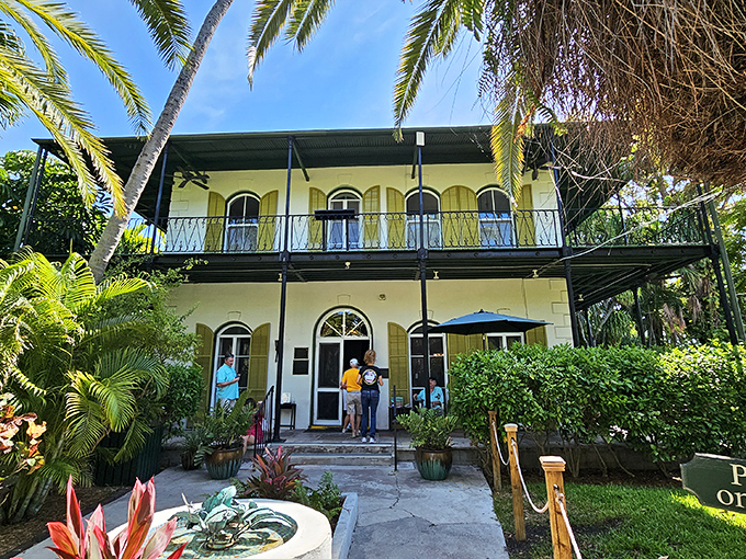 Visitors gather at the entrance, eager to step into Hemingway's world. The cats, meanwhile, wonder why these humans don't just live here permanently.