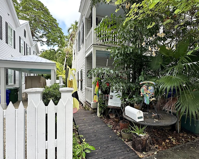 The entrance beckons with promises of tropical discoveries, where white picket fences frame a path to paradise.