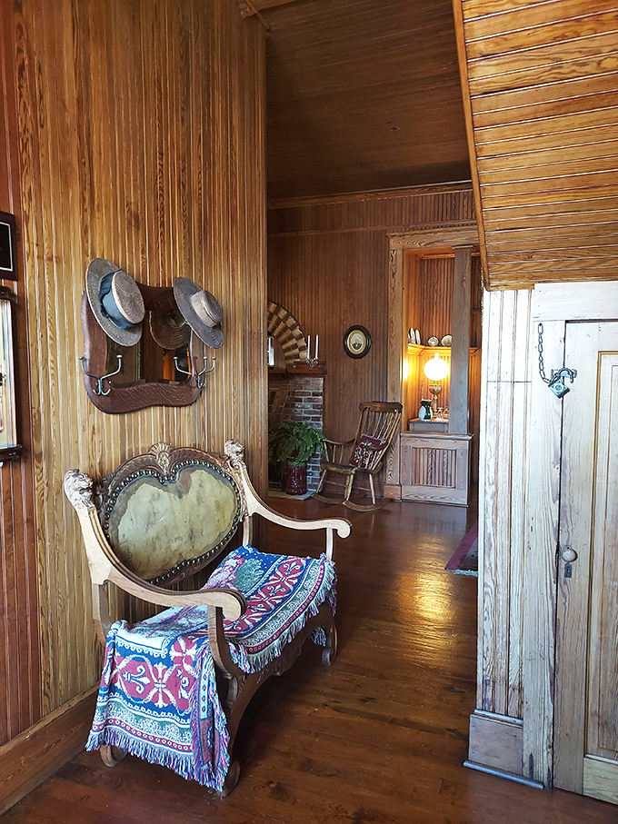 Vintage hats hang ready by the doorway, as if their owners might return any moment from an afternoon stroll along the river.