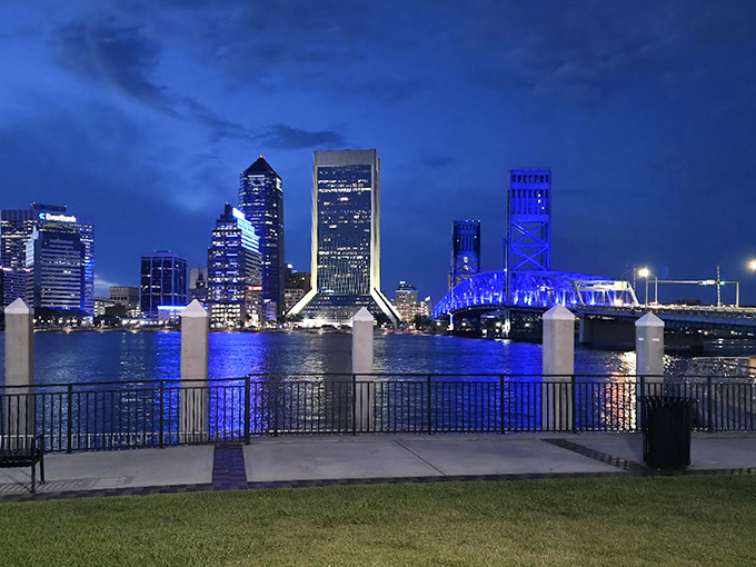 Night brings a magical transformation as the fountain's illuminated waters create a light show against Jacksonville's twinkling skyline.
