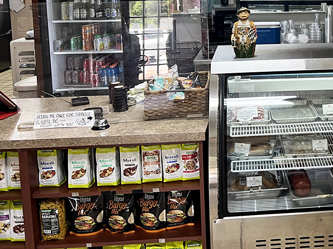 The order counter displays tempting pastries and treats, while that friendly chef figure reminds you that good food and hospitality go hand in hand.