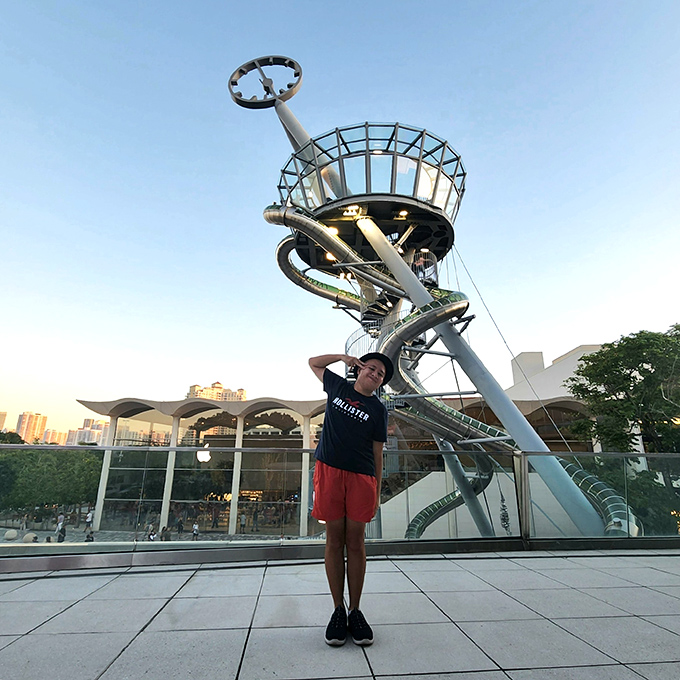 Visitors capture memories against this iconic backdrop, preserving evidence of the day they traded adult dignity for pure, uninhibited joy.