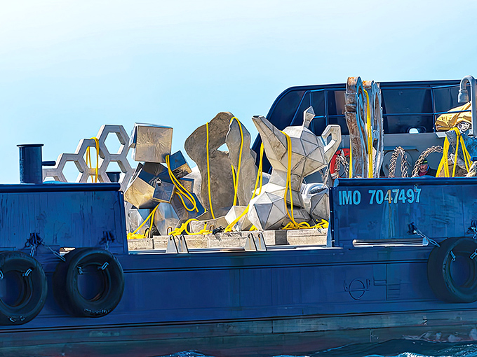 The delivery fleet carries its artistic cargo toward the horizon &ndash; next stop: 60 feet below the surface.