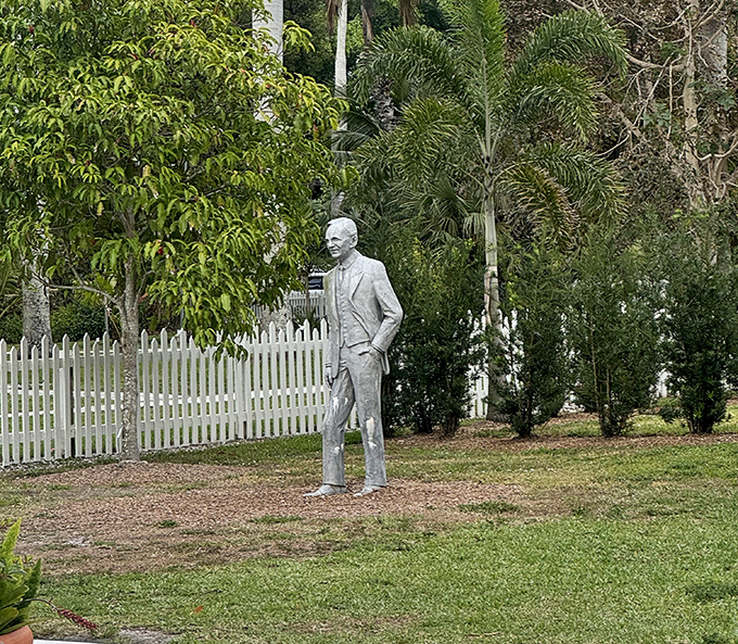 A silver Edison stands proudly among the gardens he cultivated, eternally surveying his tropical laboratory with characteristic thoughtfulness.