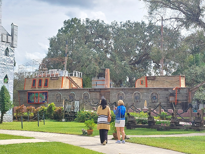 Visitors approach the wooden ship, perhaps wondering if they need sea legs for a restaurant permanently docked on grass.