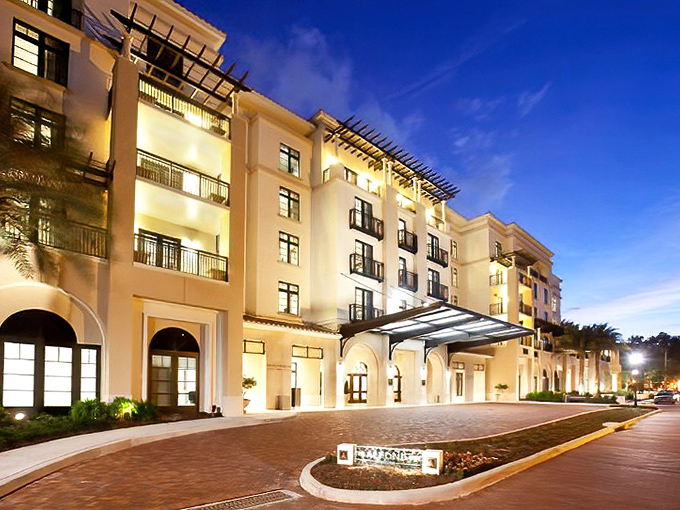 The Alfond Inn glows at twilight, its elegant architecture housing both luxury accommodations and an impressive contemporary art collection.