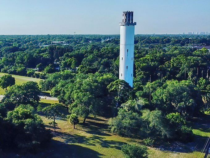 Aerial view: From above, the tower commands attention amid Tampa's lush greenery, a brilliant white landmark that's been guiding locals home for nearly a century.