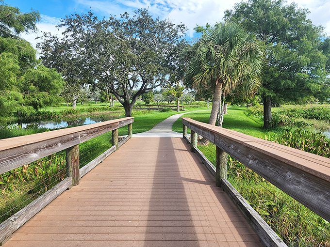 The wooden bridge beckons visitors forward into a verdant paradise, each step revealing new perspectives of this waterfront wonderland.