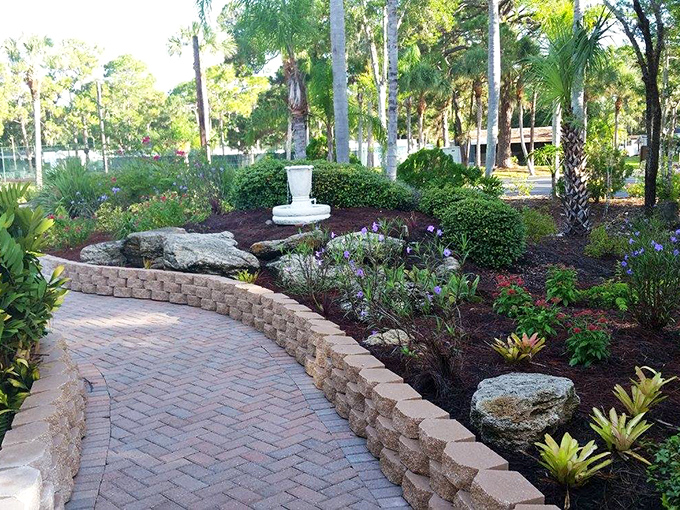 Brick pathways wind through meticulously maintained gardens, where tropical plants create colorful oases for butterflies and visitors alike.