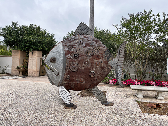 This whimsical metal fish sculpture proves that art and nature make perfect companions, especially when they come with a side of humor.