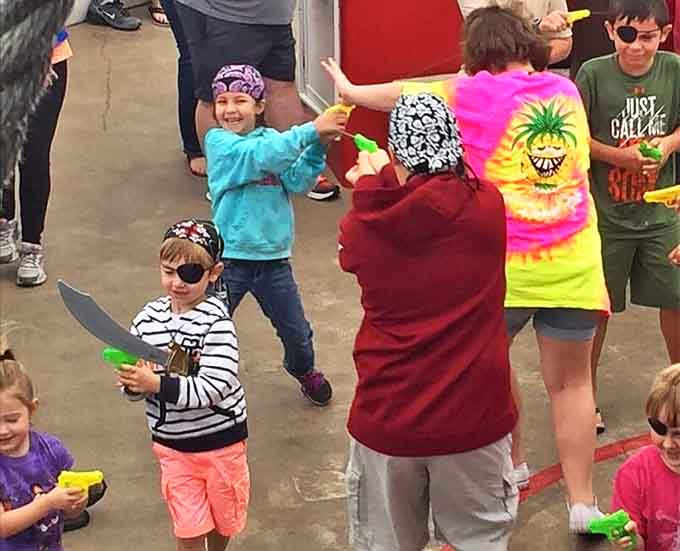 Foam swords and water guns transform mild-mannered tourists into fearsome pirates, with children leading the charge against enemy vessels.
