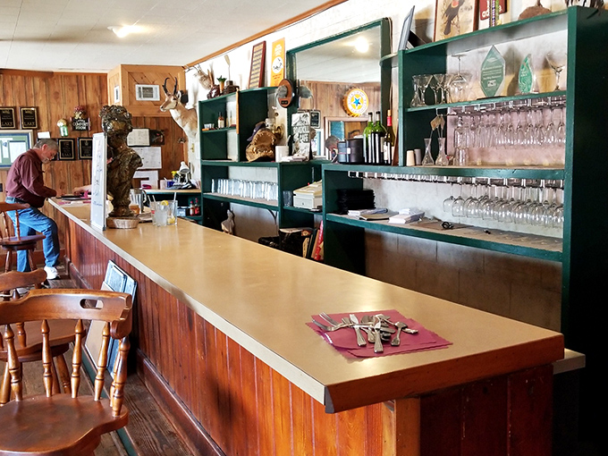 The bar counter gleams with the patina of countless elbows and conversations, a front-row seat to the restaurant's bustling yet intimate atmosphere.