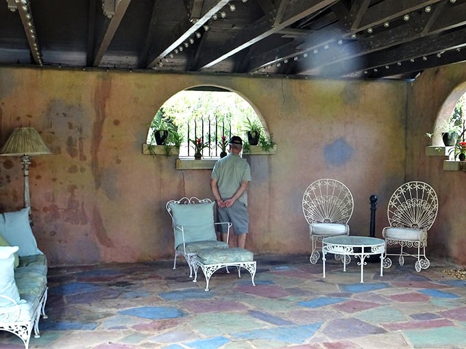 White wrought-iron furniture invites lingering conversations on this covered patio, where Florida's heat is kept at bay.