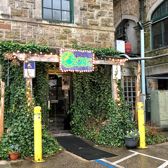 Nature reclaims architecture as ivy embraces stone &ndash; this magical doorway feels like stepping through a portal to another world of pizza possibilities.