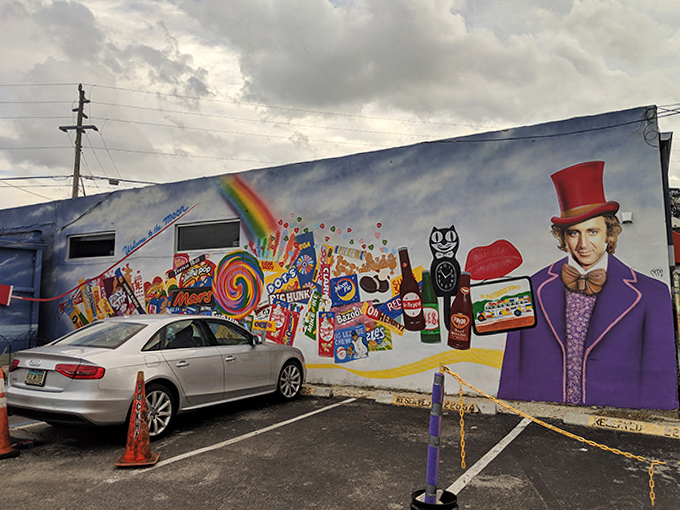 The exterior mural featuring Willy Wonka himself sets the perfect whimsical tone for the candy wonderland that awaits inside.