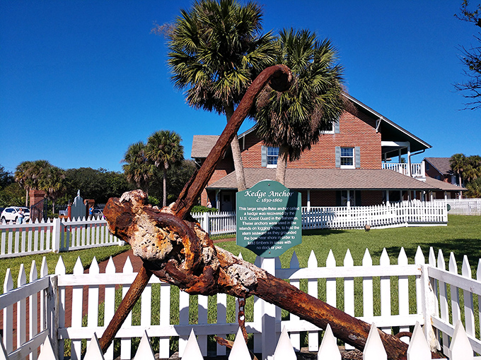 This weathered kedge anchor stands as a silent witness to countless maritime journeys, now resting peacefully in the lighthouse grounds.