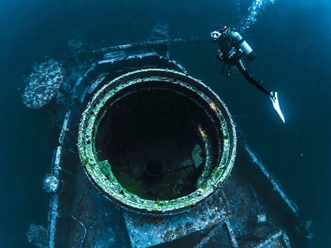 This massive circular opening once housed equipment for carrier operations &ndash; now it's a perfect frame for underwater photographers and curious fish.