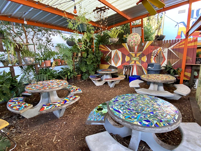 Mosaic-topped tables create a peaceful garden oasis. Artistic details extend to every corner of this uniquely immersive dining experience.