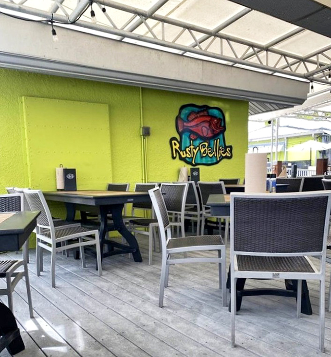 Outdoor seating with that signature lime-green wall &ndash; where the Gulf breeze serves as nature's air conditioning.