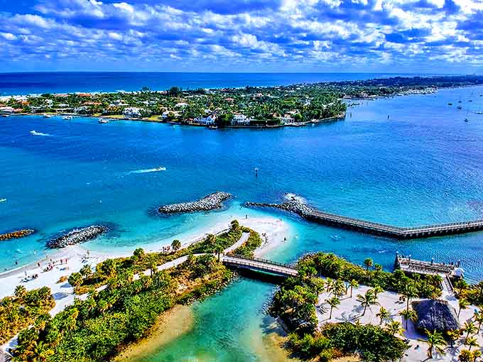 Bird's-eye brilliance! This aerial shot reveals Peanut Island's perfect positioning – a green jewel set in waters ranging from deep blue to electric turquoise.