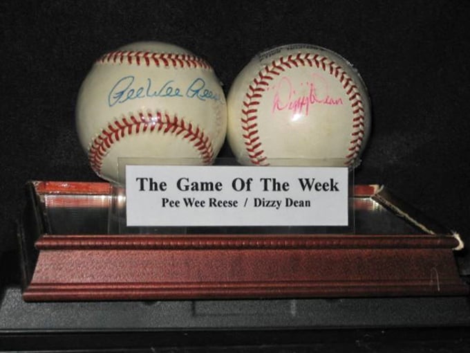 Game-used balls signed by legends sit side by side, representing moments when history was made with a swing.