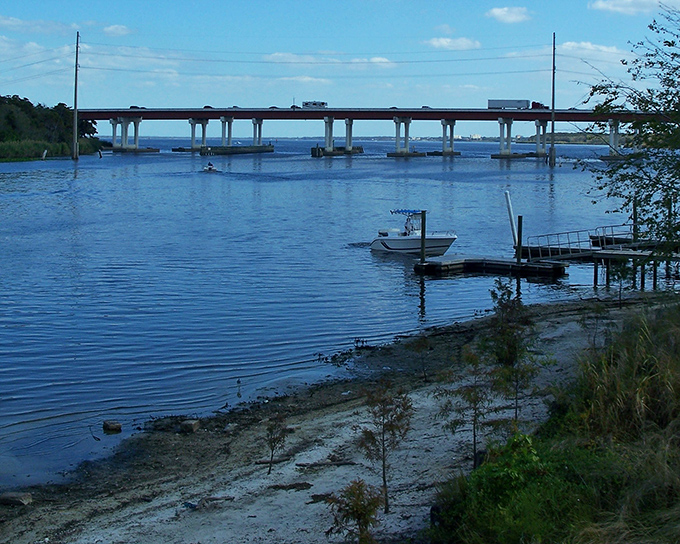 The St. Johns River Veterans Memorial Bridge spans calm waters, while beneath the surface and asphalt lie stories waiting to be uncovered.