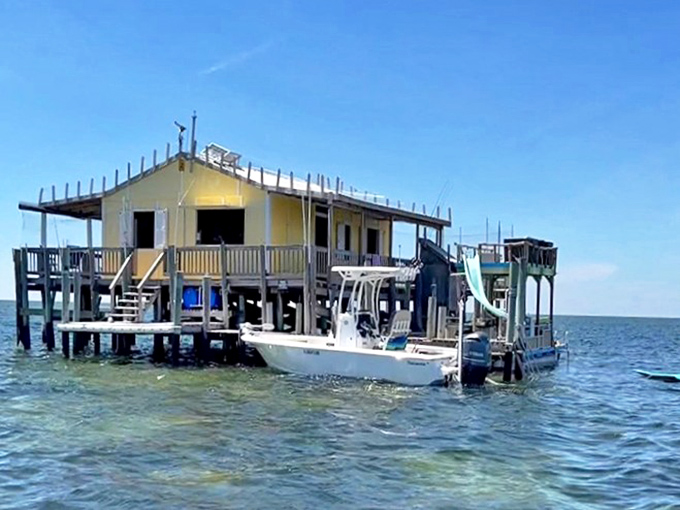 Weekend warriors dock their boat beside this stilt house complete with water slide &ndash; Florida's version of a backyard pool.