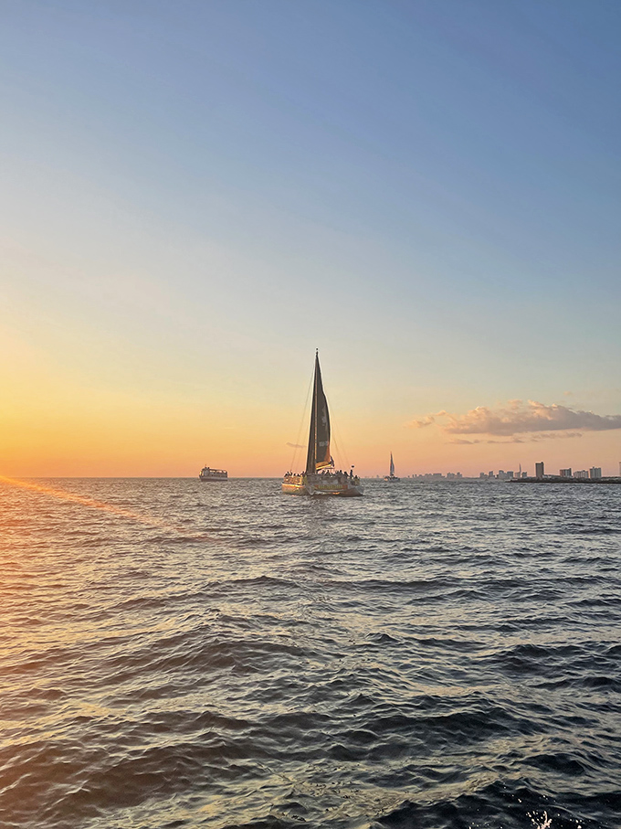 Sailboats silhouetted against a golden sunset &ndash; Shell Island's day ends with nature's light show, painting the sky in colors no artist could fully capture.